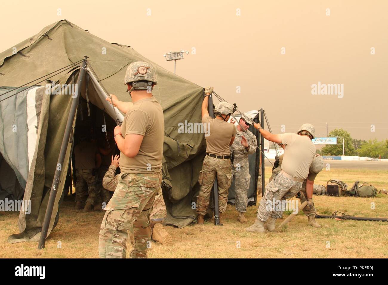 Under a gray, smoky sky, U.S. Army Soldiers from the 270th Military ...