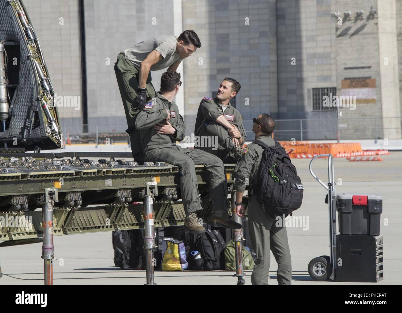 A U.S. Air Force aircrew members take a break while waiting to up load ...