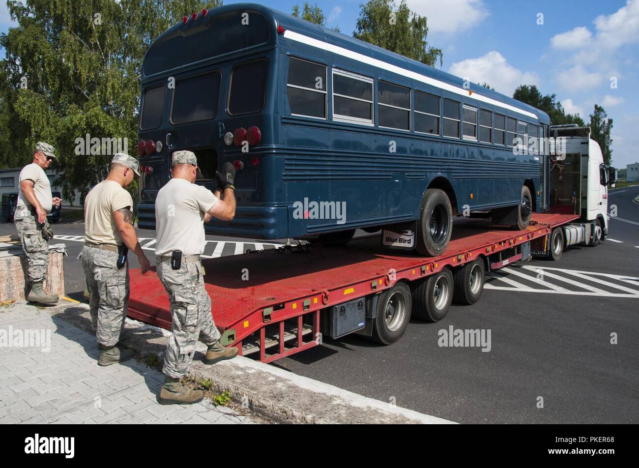 U.S. Air National Guard Airmen guide a truck to an off-loading dock ...
