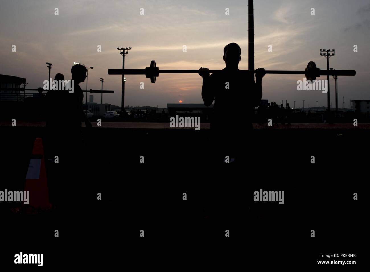 Marines perform curling exercises during a Force Fitness Instructor ...