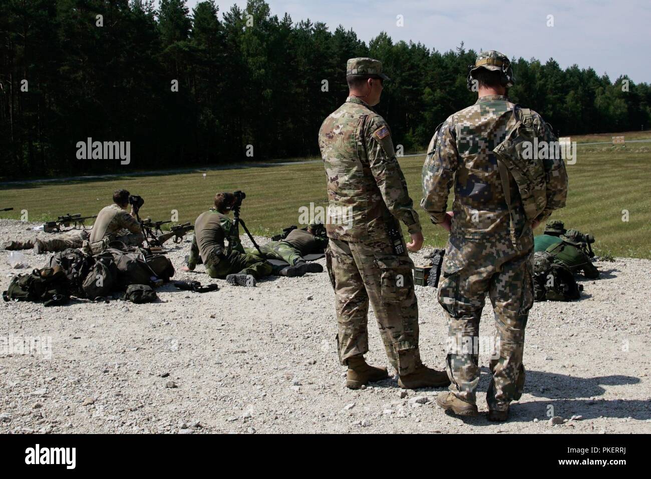 U.S. Army Staff Sgt. Richard Harris, left, assigned to the 10th Army ...