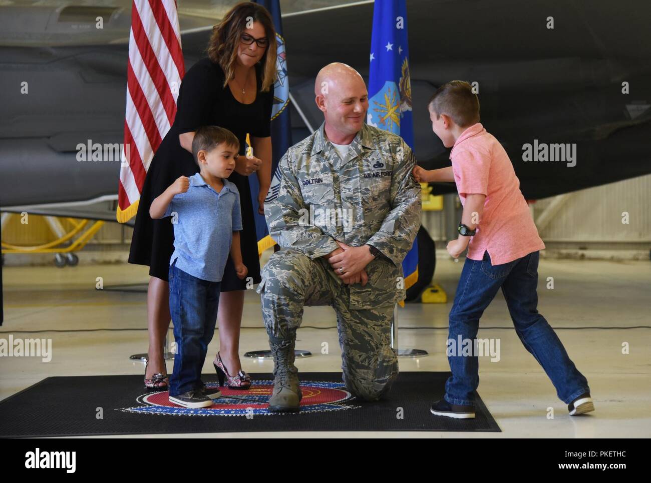 Chief Master Sgt. Matthew Coltrin's family assists in putting on his ...