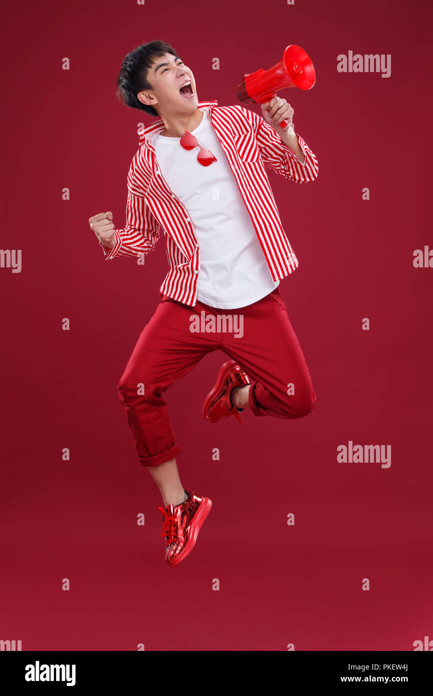 Young man holding a microphone Stock Photo - Alamy