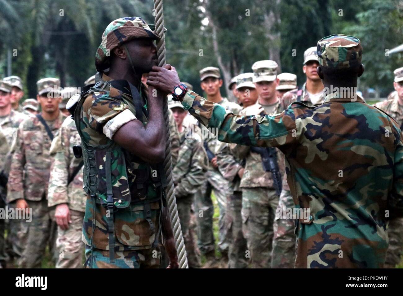 U.S. Army Soldiers receive instructions on the rope swing obstacle at ...