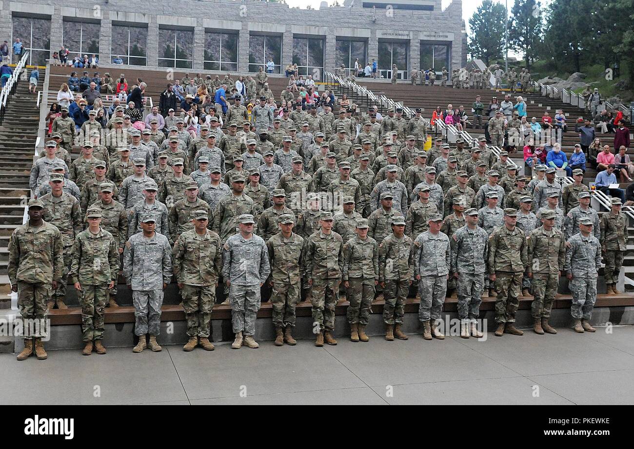 U.S. Army National Guard officer candidates stand at attention to be ...