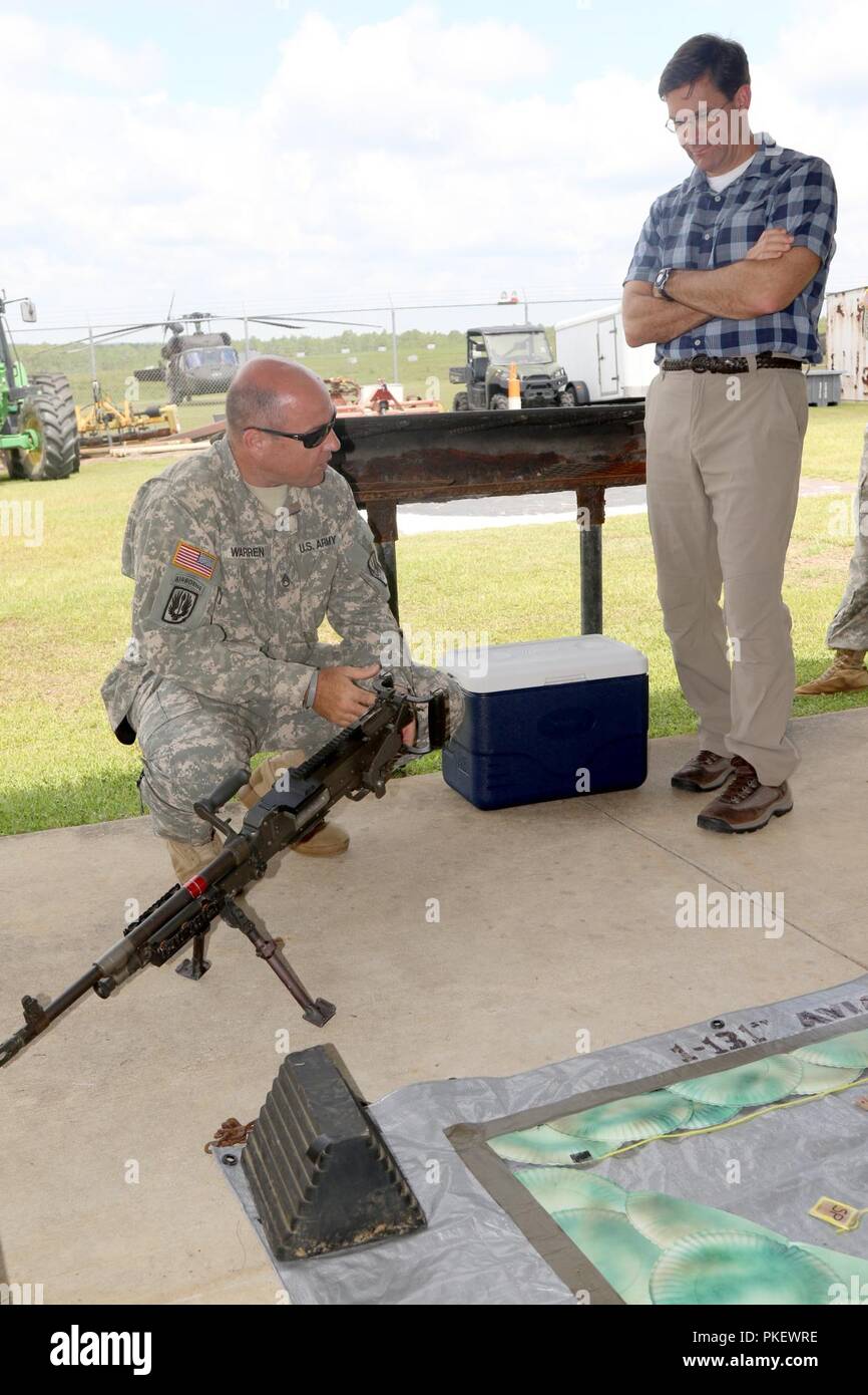 Secretary of the Army Mark Esper receives a weapon safety briefing from ...
