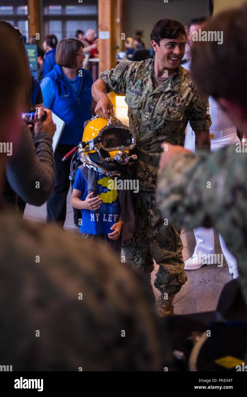 SEATTLE (August 02, 2018) Navy Diver 2nd Class Tyler McLaughlin helps a ...