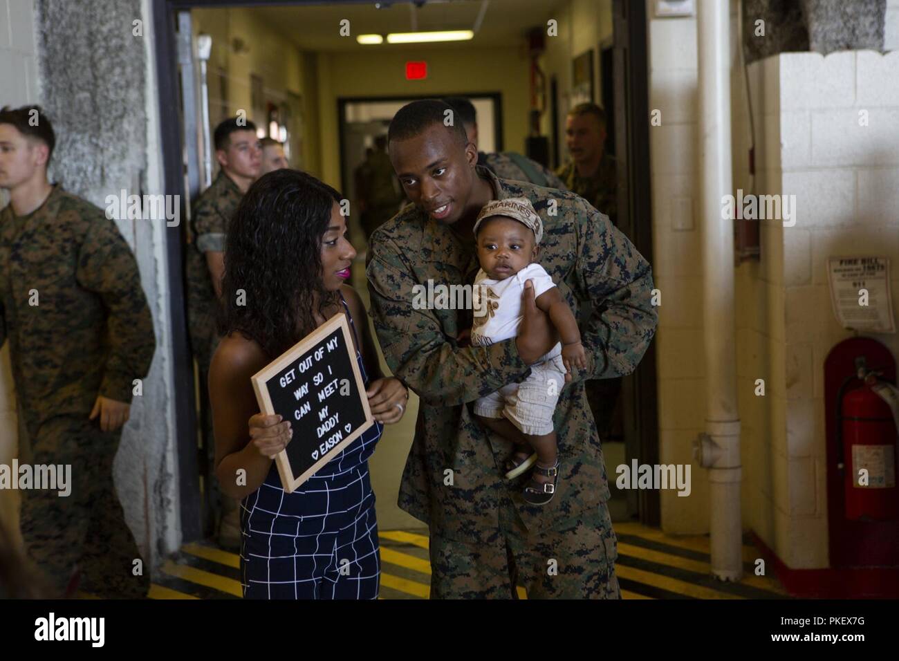 U.S. Marine Cpl. Delaurence Harmon greets his family after returning ...