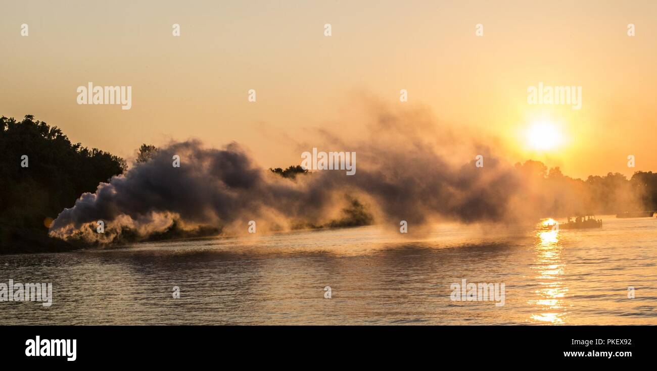 Smoke canisters are used to simulate a chemical agent attack during ...