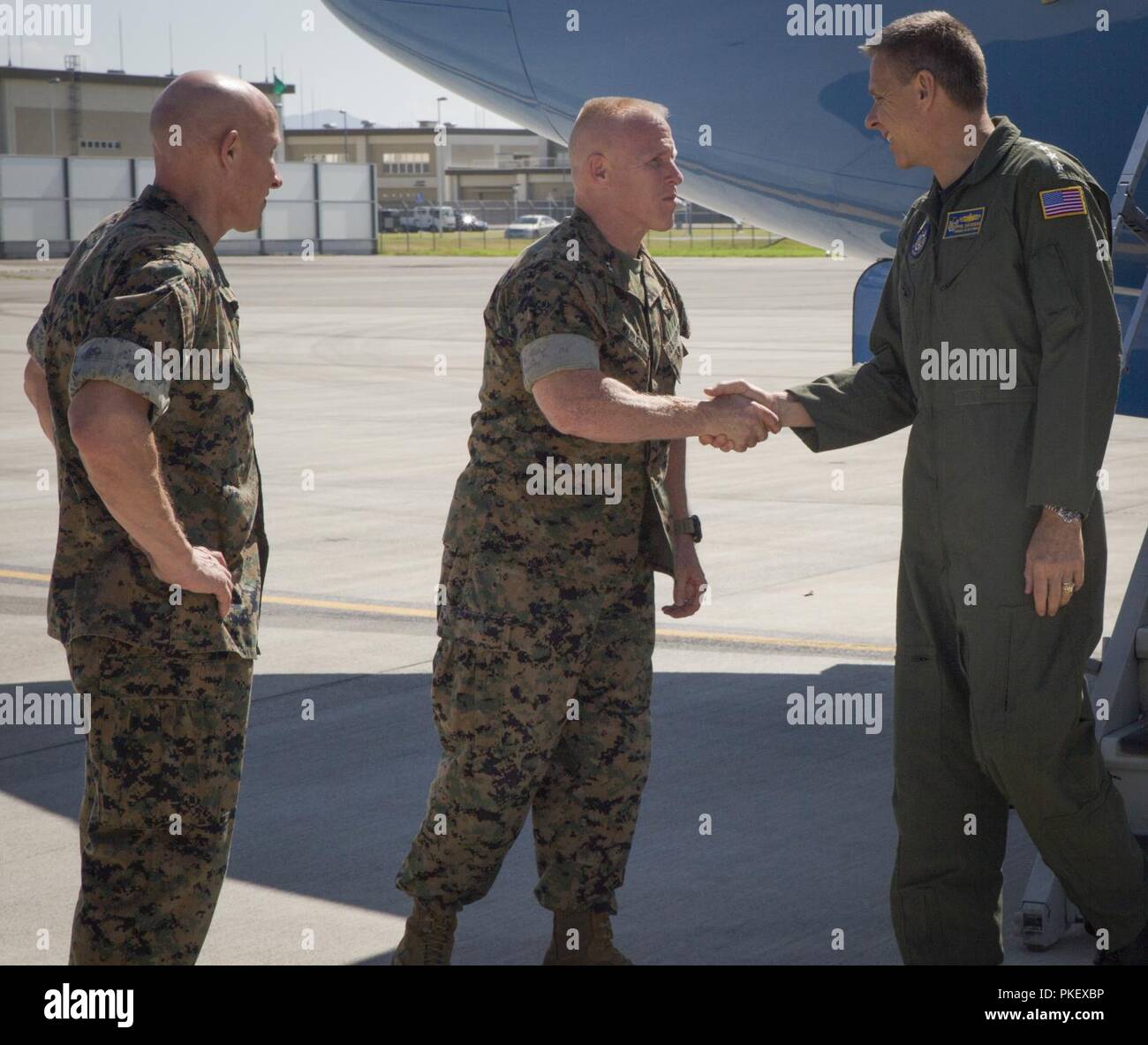 Maj. Gen. Thomas Weidley (middle) greets Adm. Phil Davidson (right) as ...