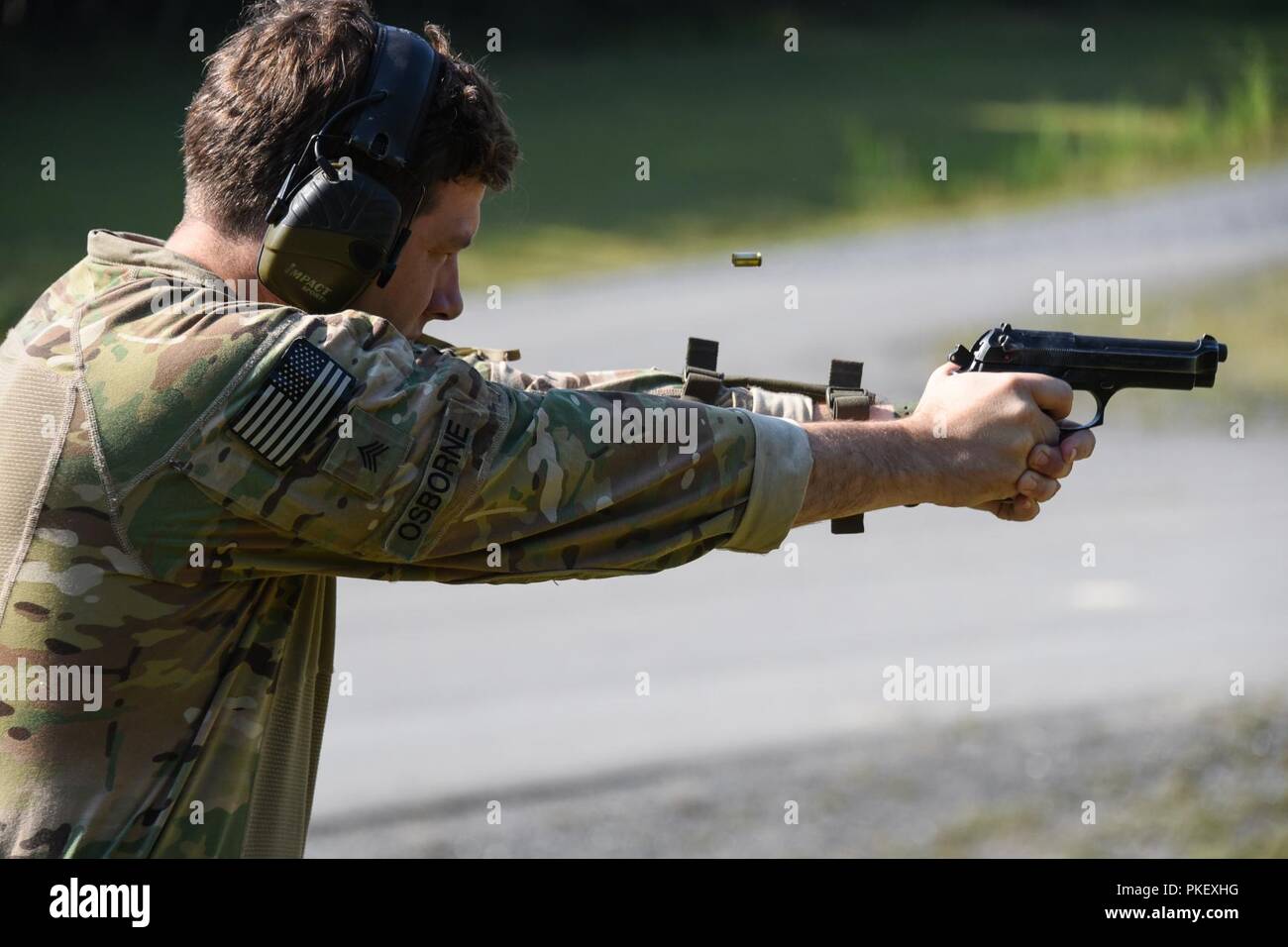 A U.S. Soldier with 173rd Airborne Brigade fires his M9 pistol at the ...