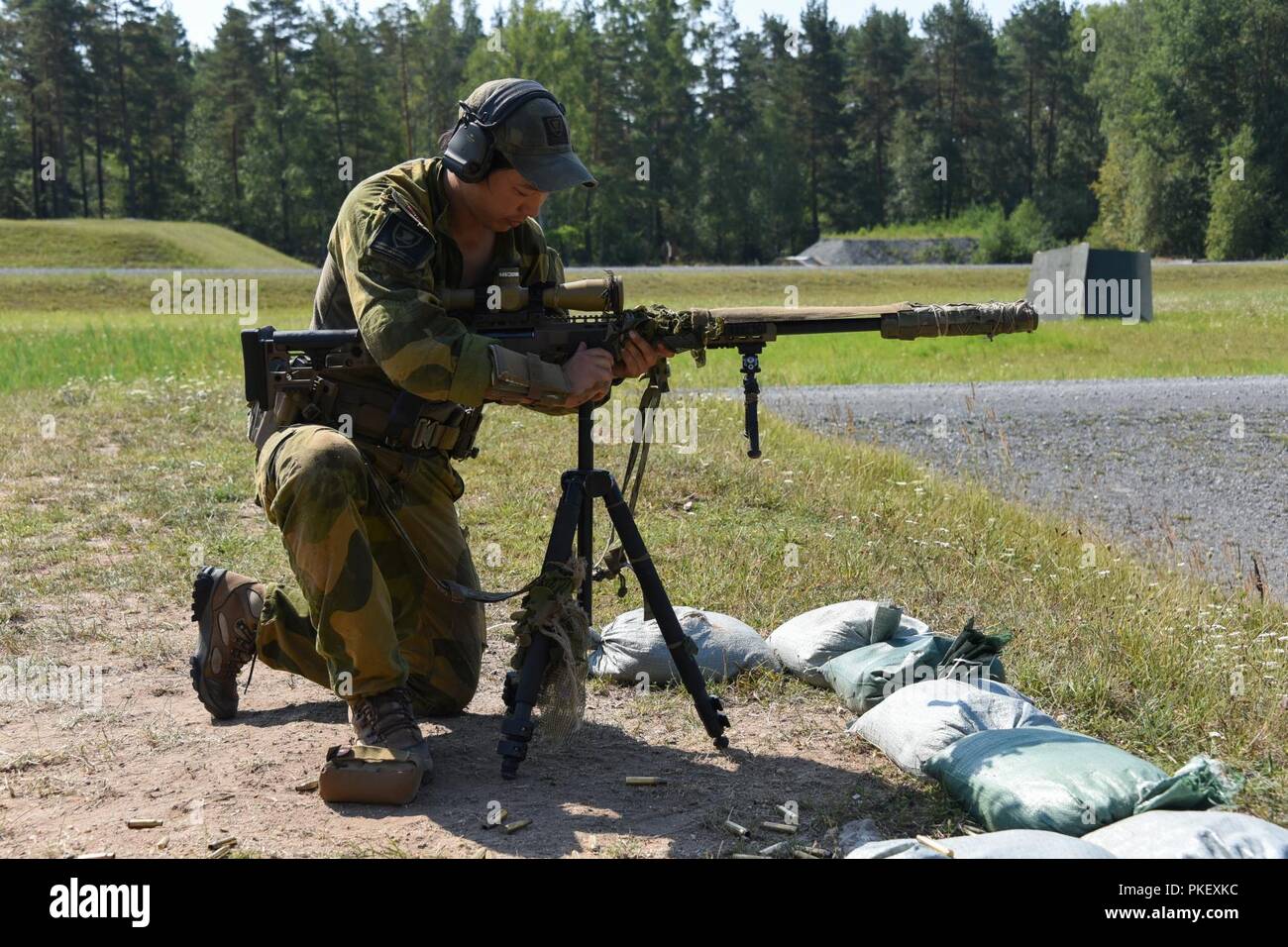 A Norwegian soldier mounts his sniper rifle on a tripod at the ...