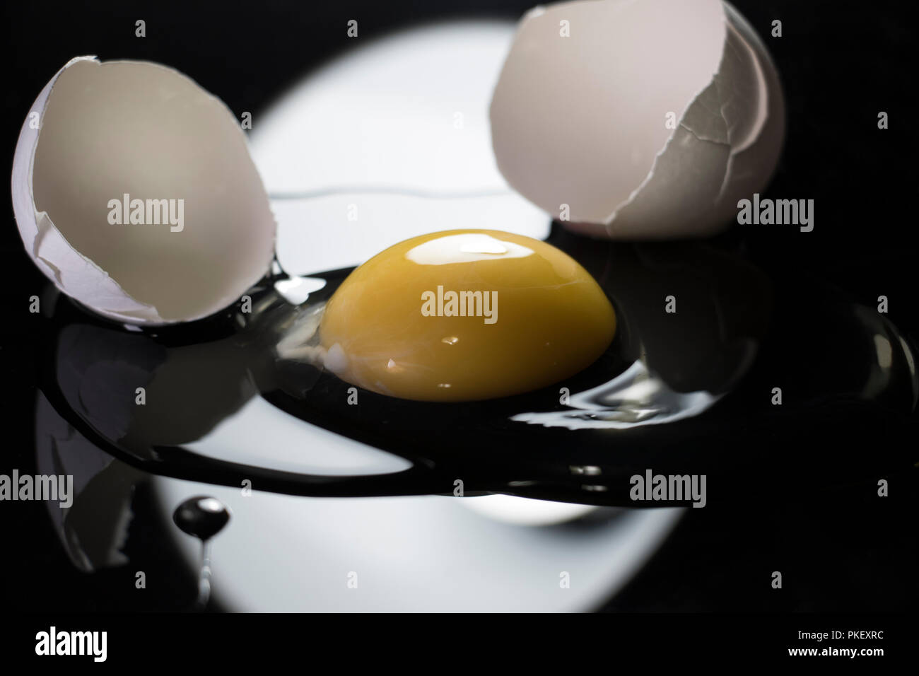 Cracked egg yolk with split shell Stock Photo - Alamy
