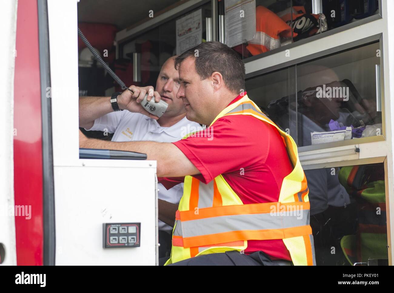 Members of the 788th Civil Engineer Fire Department monitor the scene ...