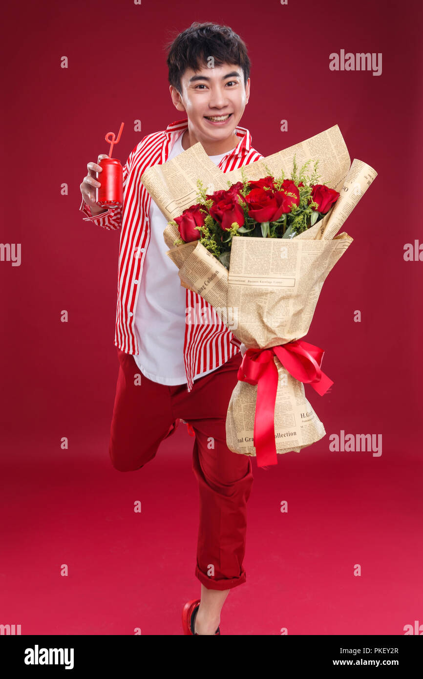 The young man with roses Stock Photo - Alamy