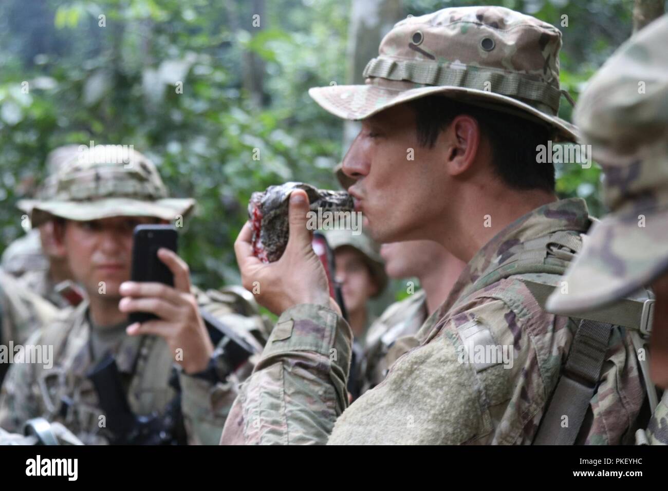 A U.S. Army Soldier kisses the head of the python while preparing to ...