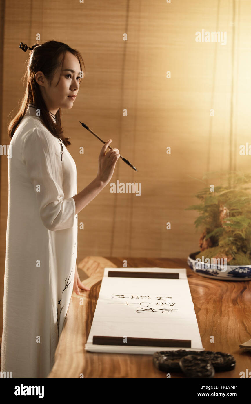 Young women in practice calligraphy Stock Photo - Alamy