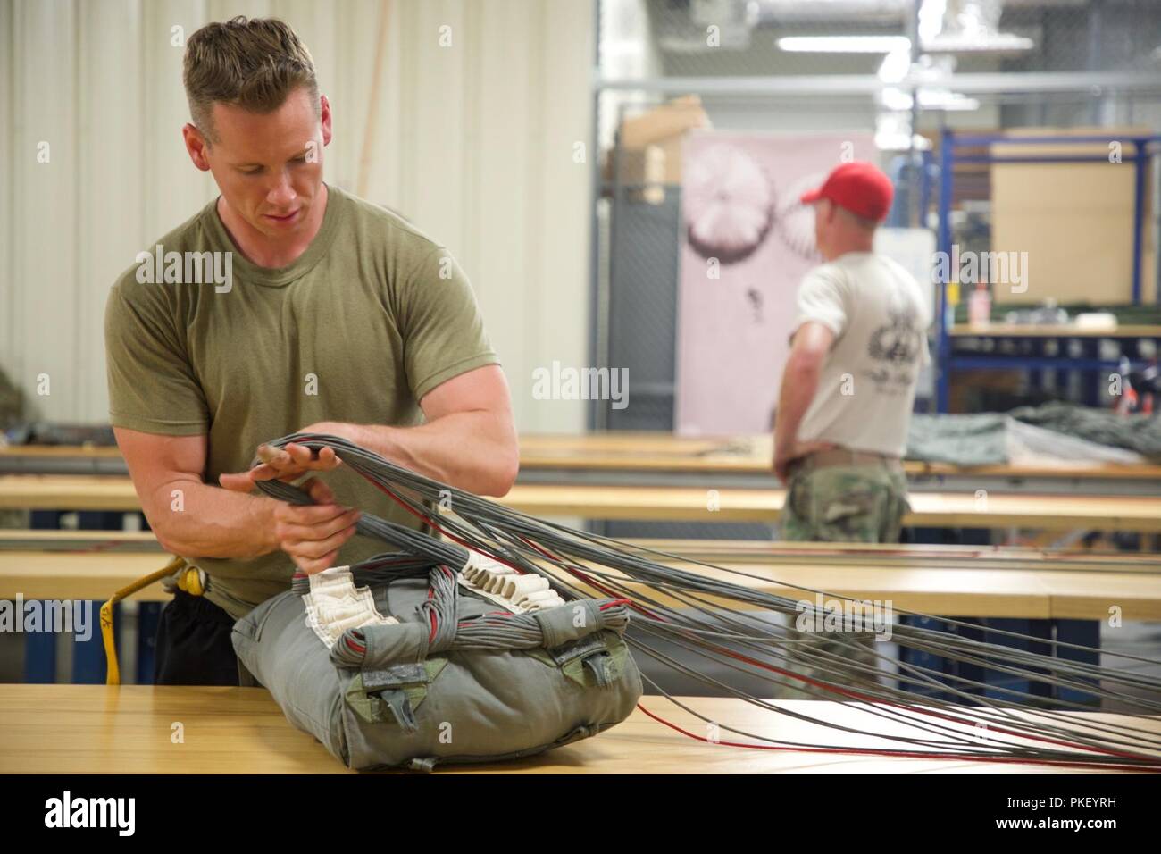 A U.S. Army Spc. David Richey, assigned to 338th Quartermaster, repacks ...