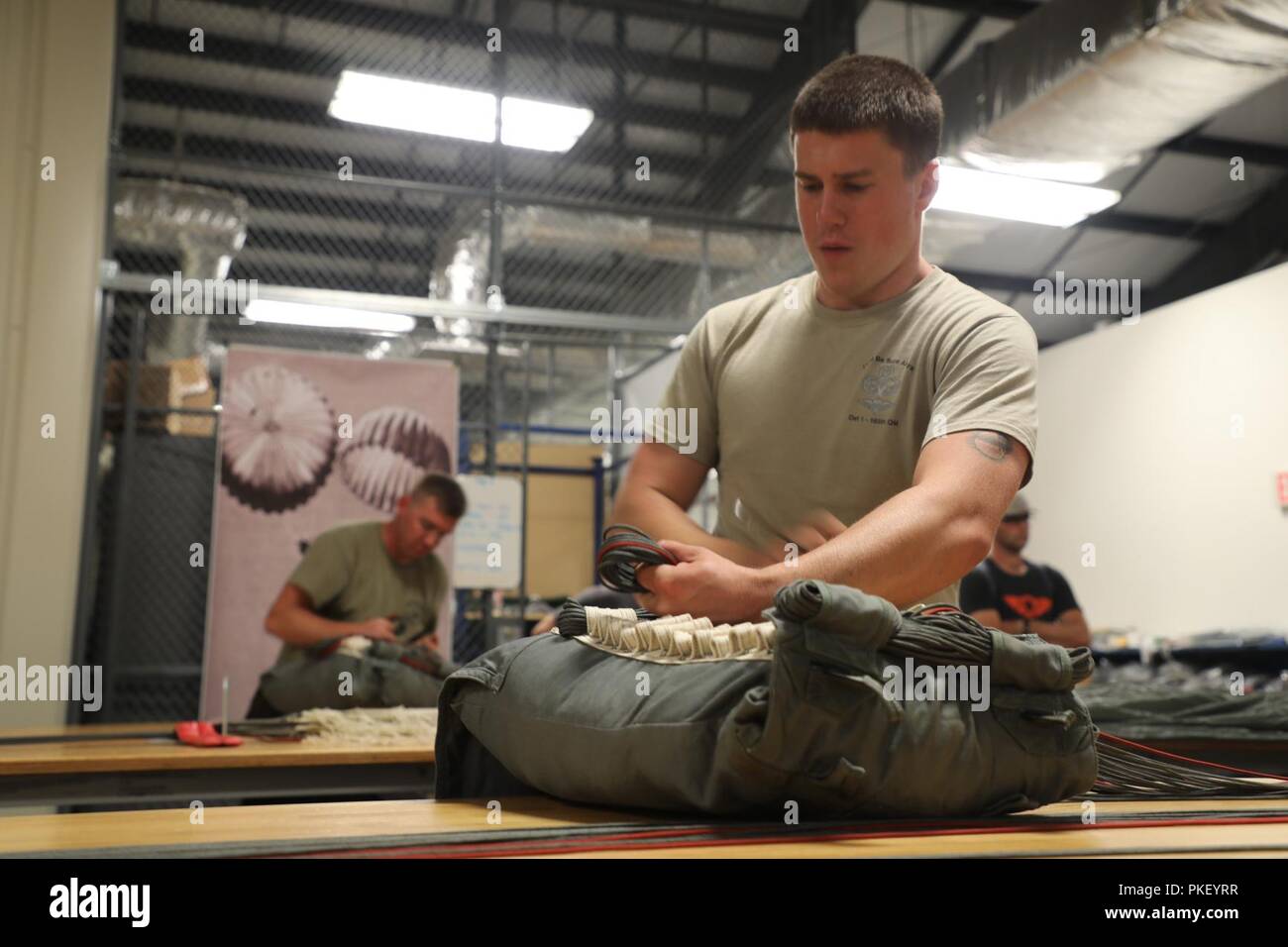 U.S. Army Spc. Alex Letner, assigned to 338th Quartermaster, repacks ...