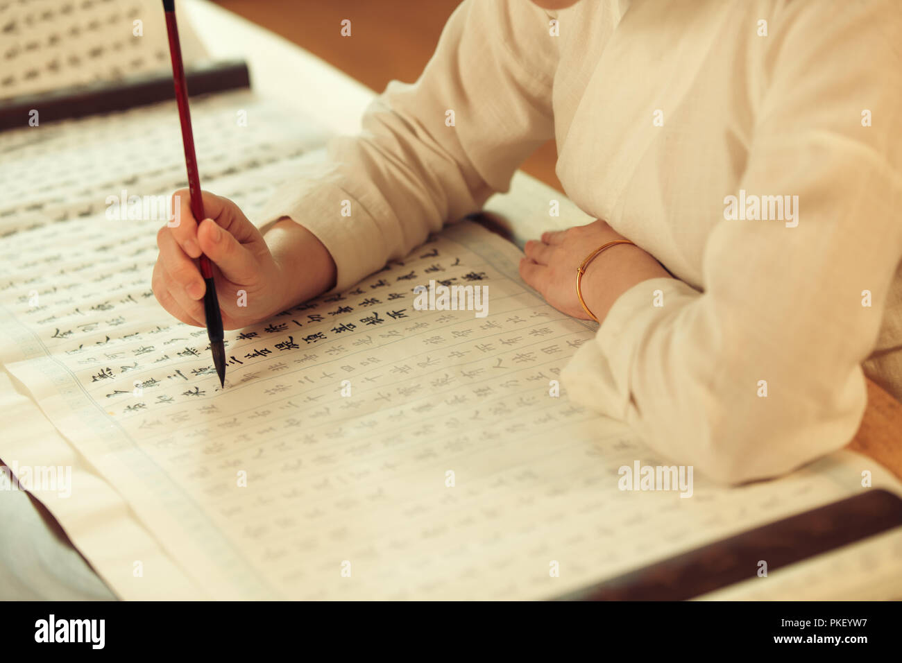 Young women in practice calligraphy Stock Photo - Alamy