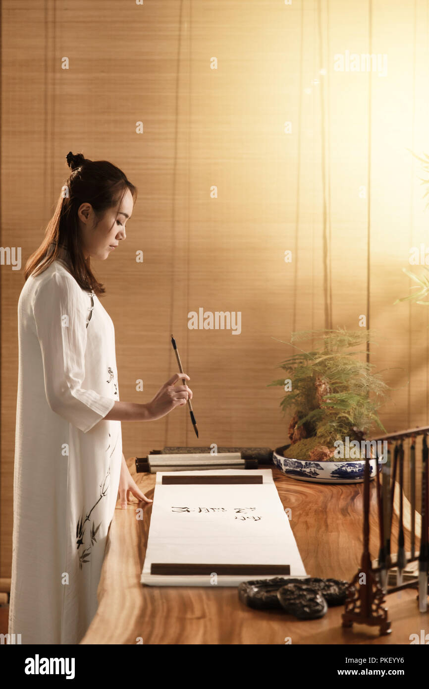 Young women in practice calligraphy Stock Photo - Alamy