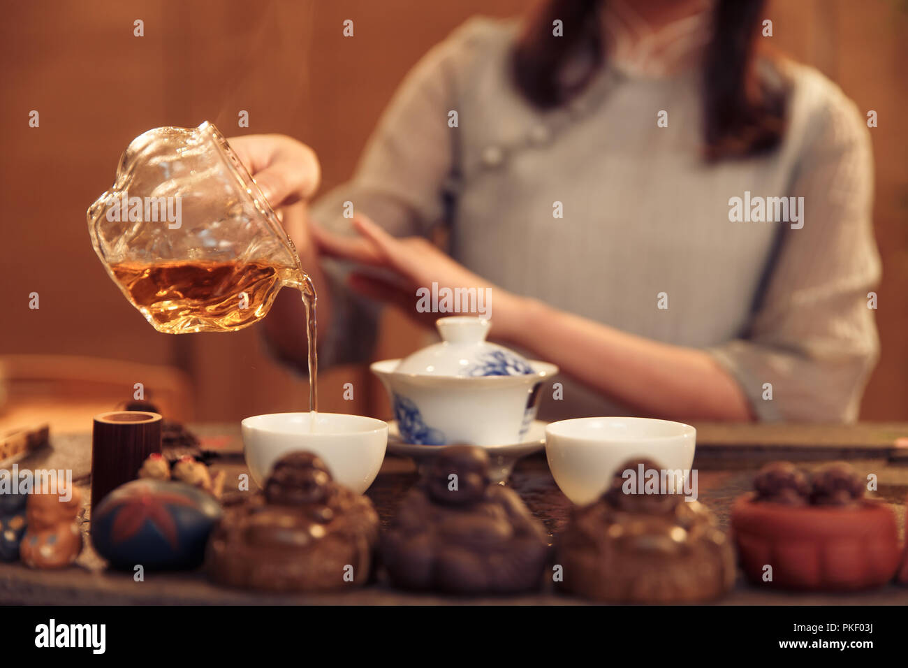 Young women show tea art Stock Photo - Alamy