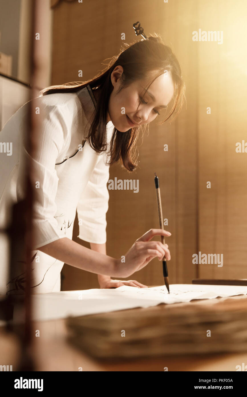 Young women in practice calligraphy Stock Photo - Alamy
