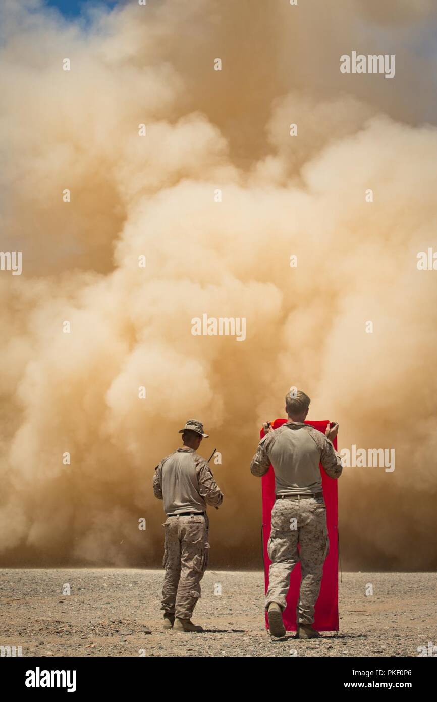 U.S. Marine Corps Sgt. Kaleb Coy, left, and Sgt. Elijah Smith, fire ...