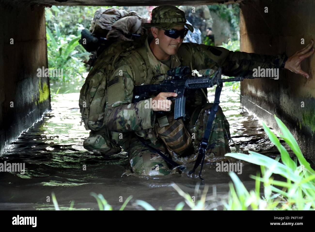 A U.S. Army Soldier wades through the water of the jungle during Jungle ...