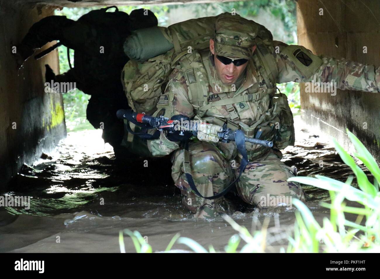 A U.S. Army Soldier wades through the water of the jungle during Jungle ...