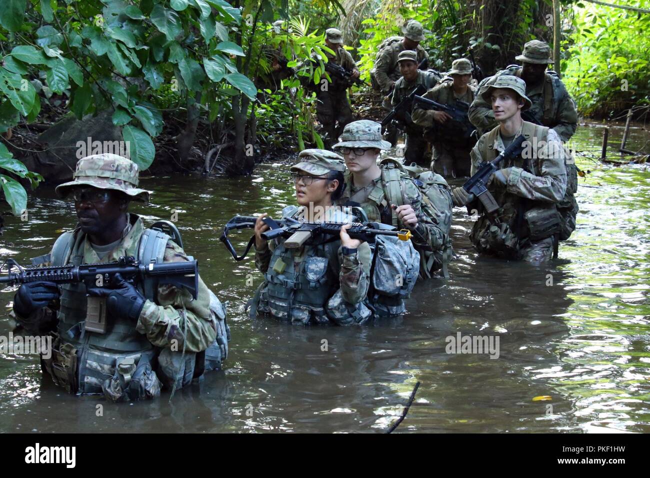 U.S. Army Soldiers wade through the water of the jungle during Jungle ...
