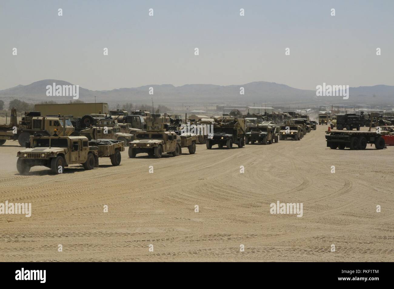 A convoy of vehicles from the 56th Stryker Brigade Combat Team rolls ...