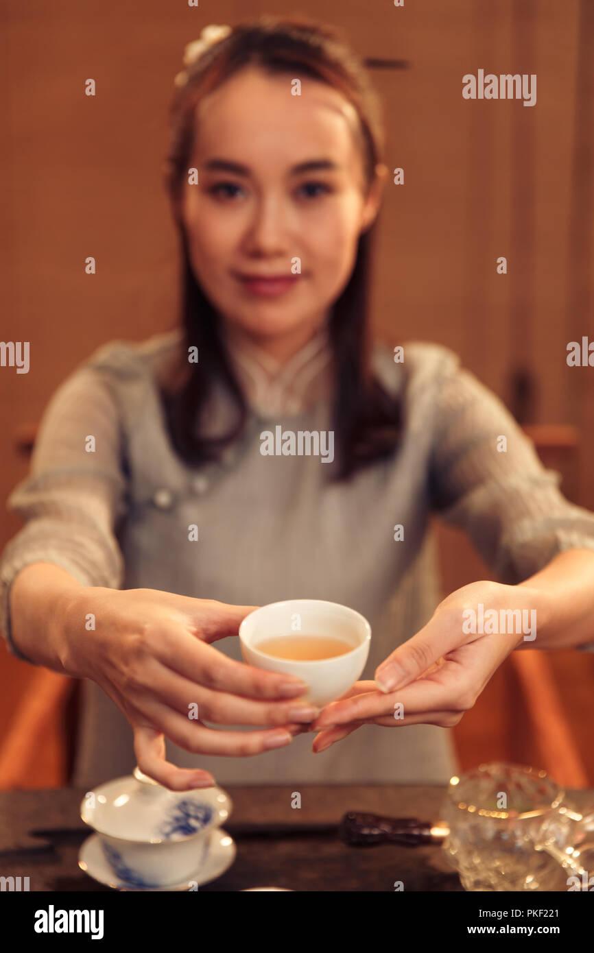 Young women show tea art Stock Photo - Alamy