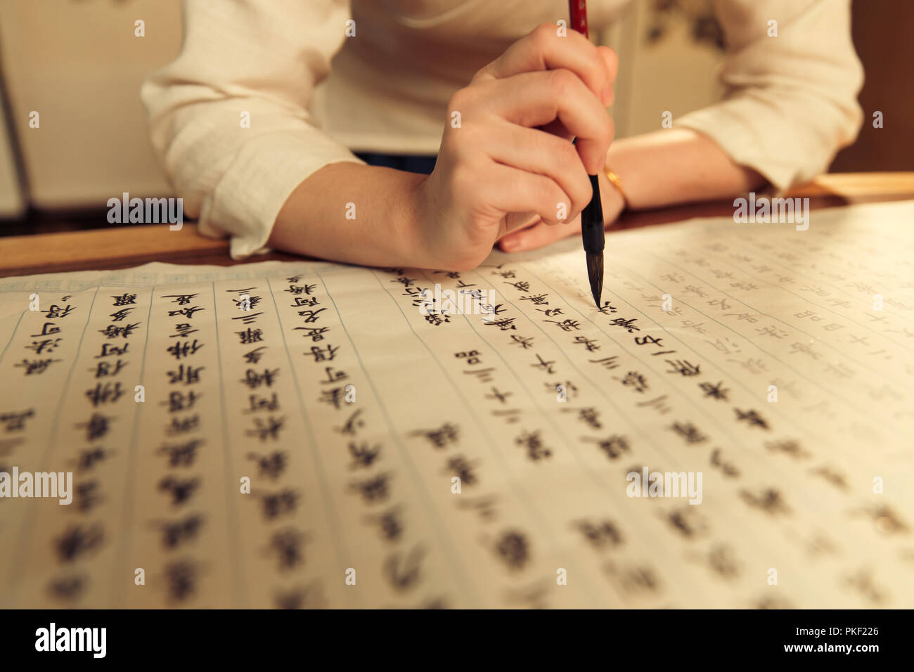 Young women in practice calligraphy Stock Photo - Alamy