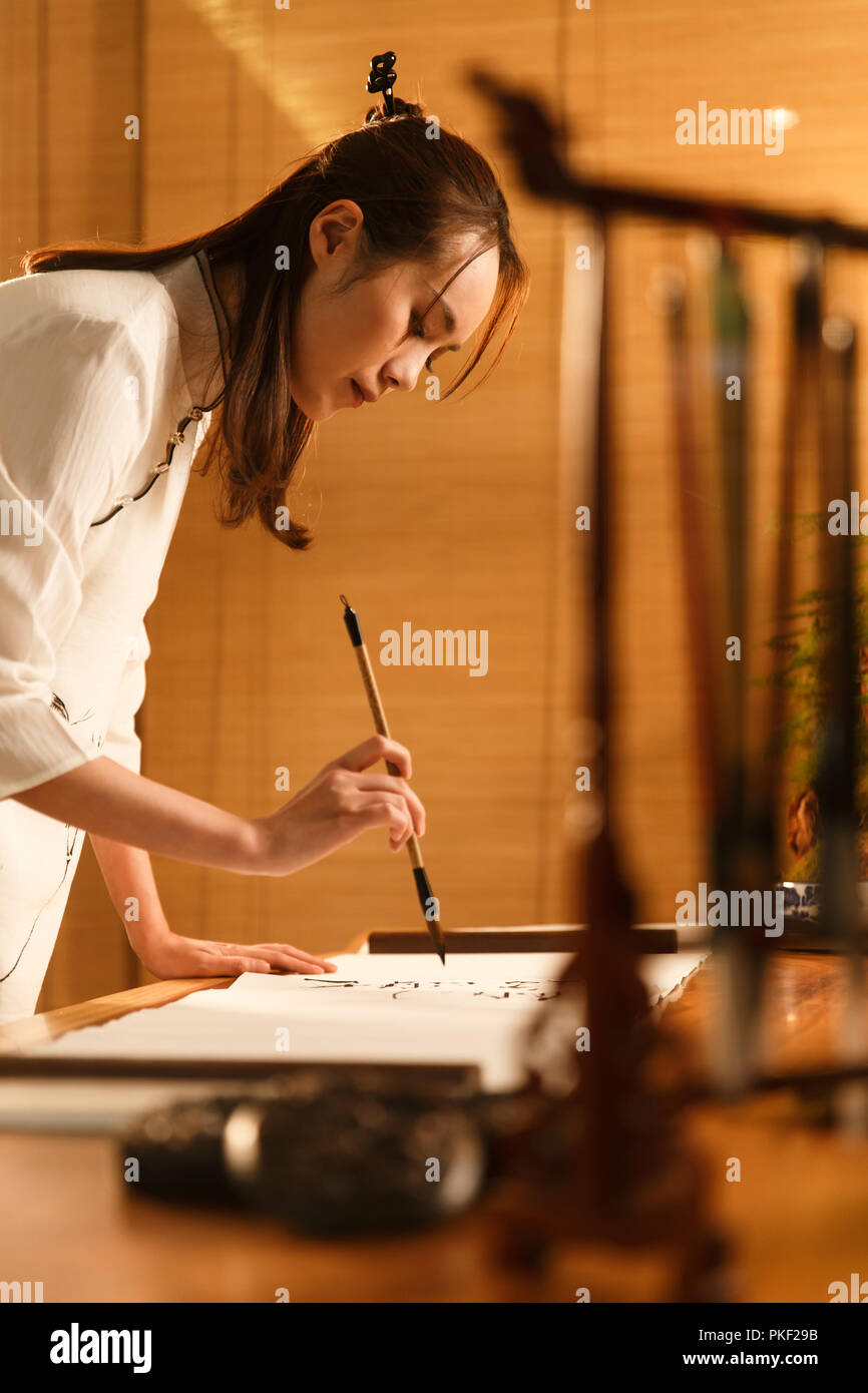 Young women in practice calligraphy Stock Photo - Alamy