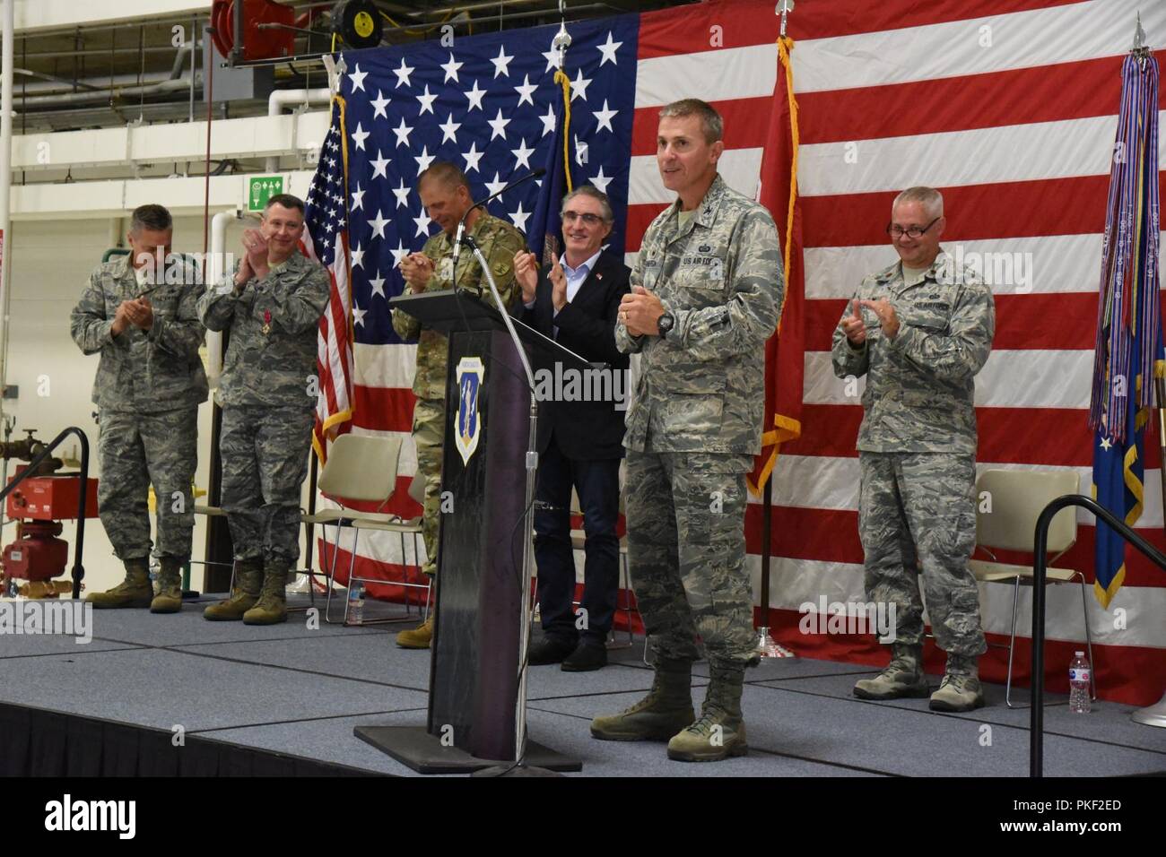 Col. Darrin Anderson addresses the 119th Wing unit members standing in ...