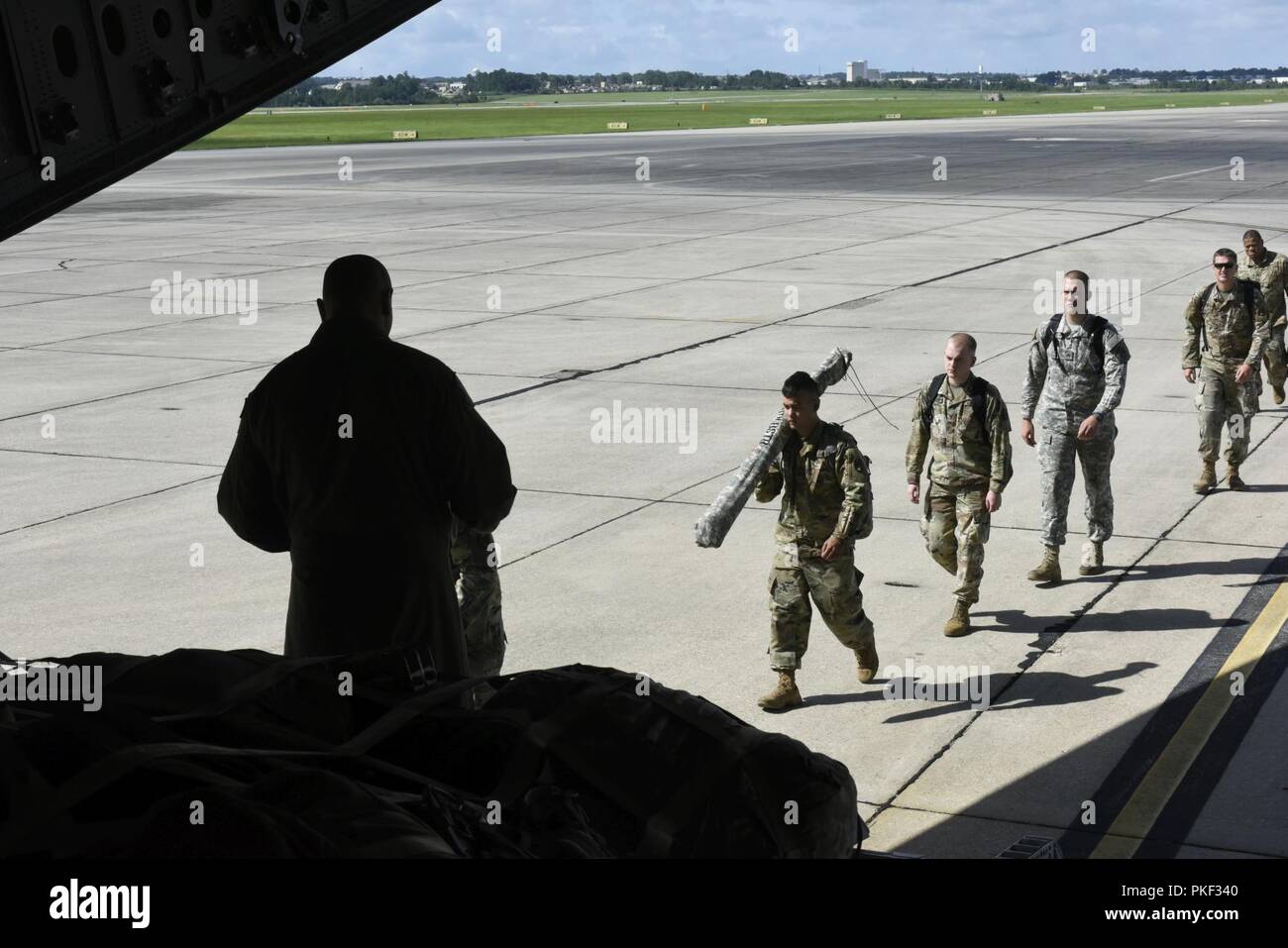 U.S. Air Force Master Sgt. Jason Hutton (Left) counts Army passengers ...