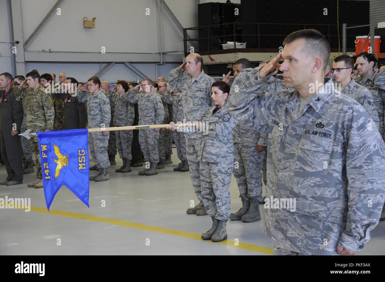 Airmen from the 142nd Fighter Wing render a formal salute during the ...