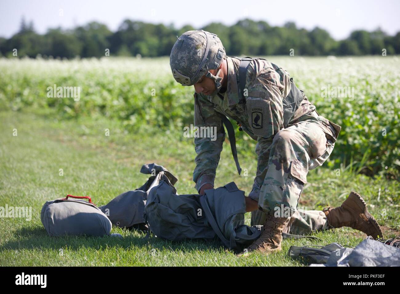 A U.S. Army Paratrooper packs up his MC-6 parachute after completing a ...