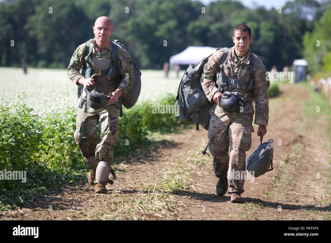 Two U.S. Army Paratroopers carries their MC-6 parachutes off of Castle ...