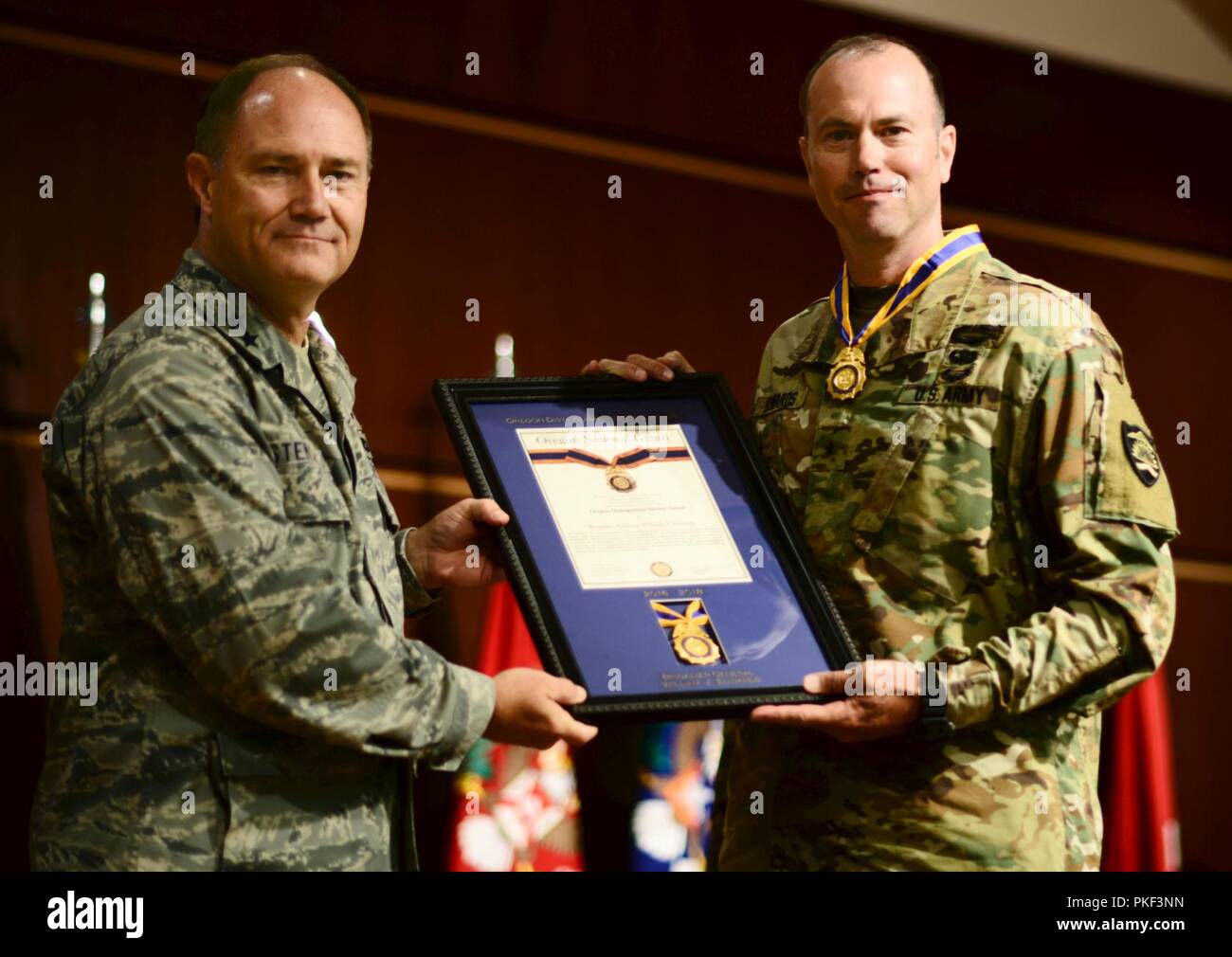 Maj. Gen. Michael E. Stencel (left), Adjutant General, Oregon, presents ...