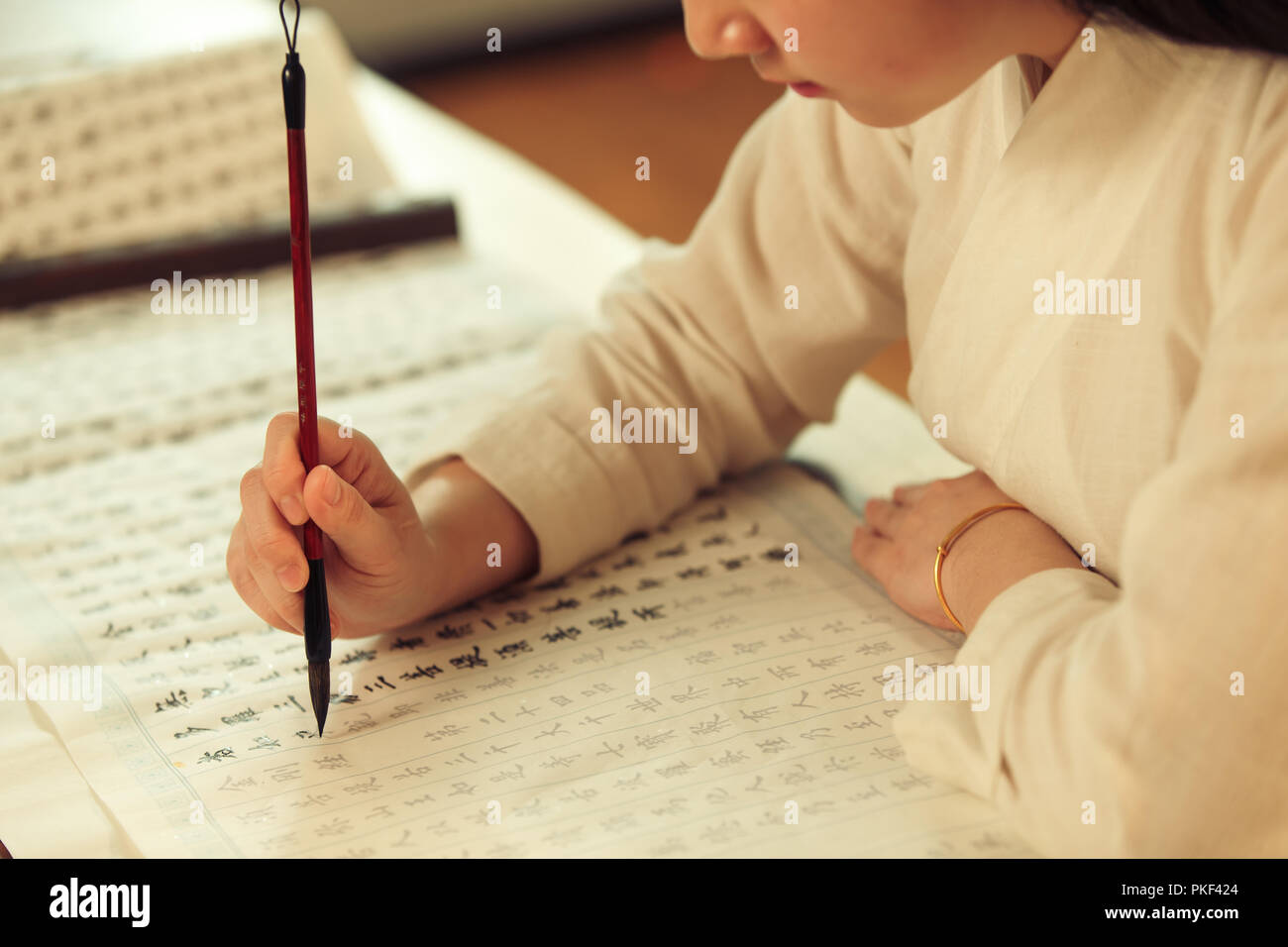 Young women in practice calligraphy Stock Photo - Alamy