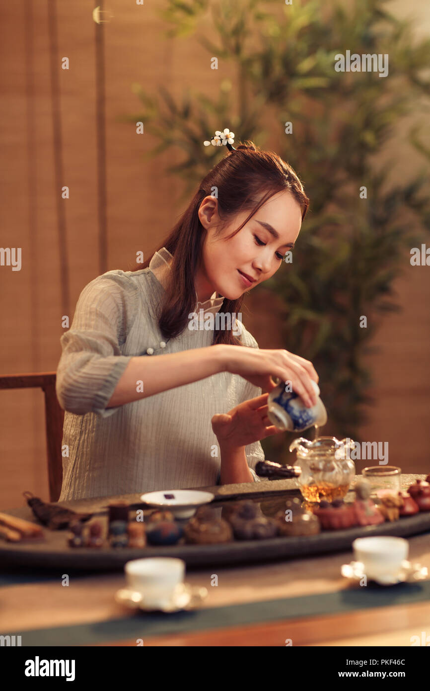 Young women show tea art Stock Photo - Alamy