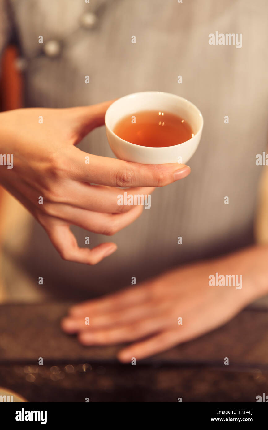 Young women drinking tea Stock Photo - Alamy