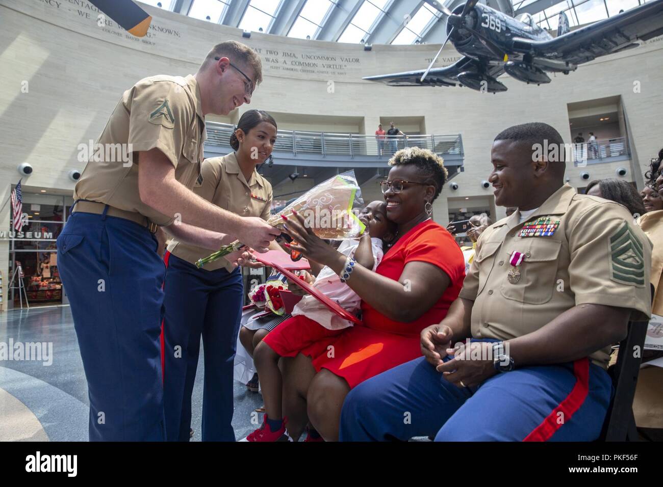 U.S. Marines with Security Battalion (SEC BN) present flowers to the ...
