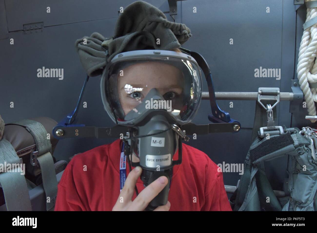 A boy dons an oxygen mask in the cockpit of an MC-130J Commando at RAF ...