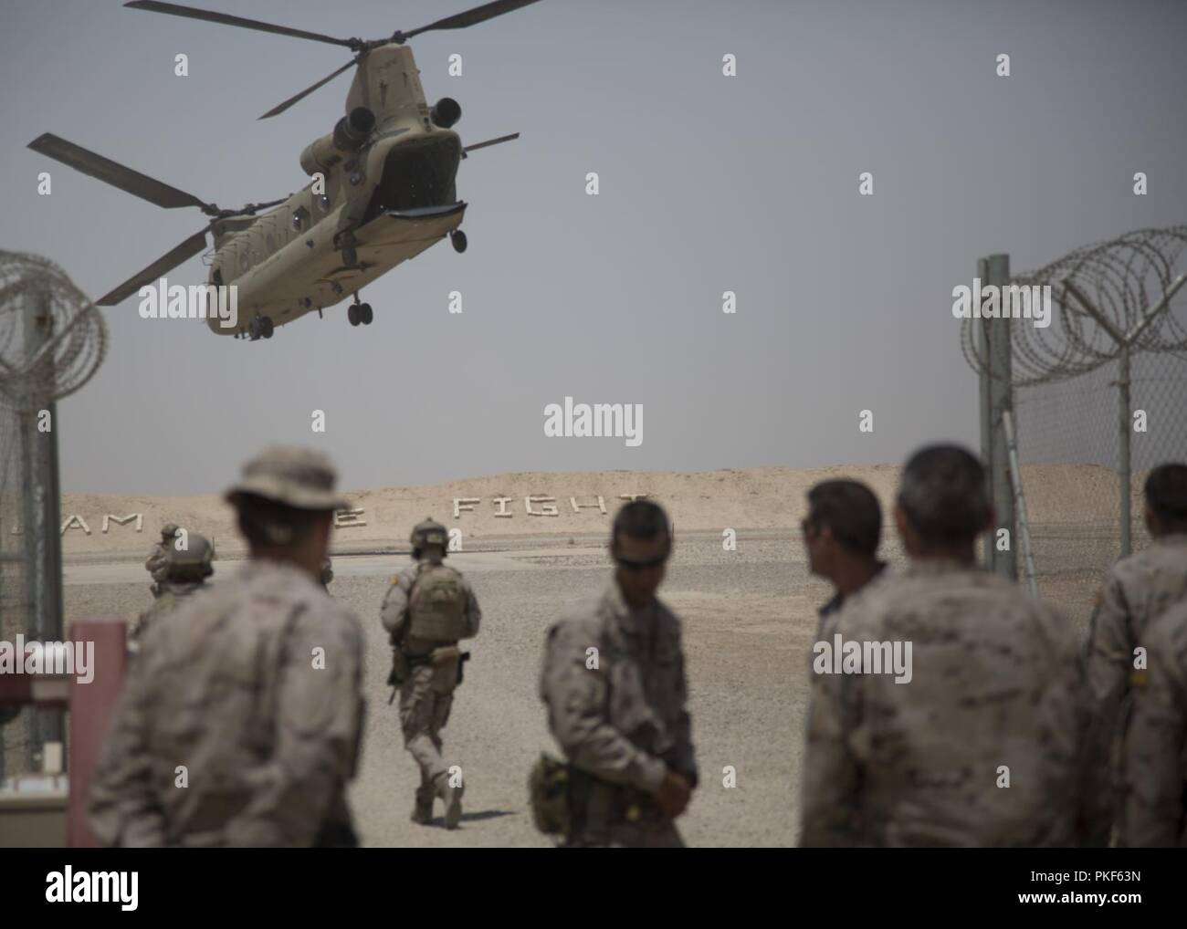 Members of the Spanish army watch as a helicopter carrying U.S ...