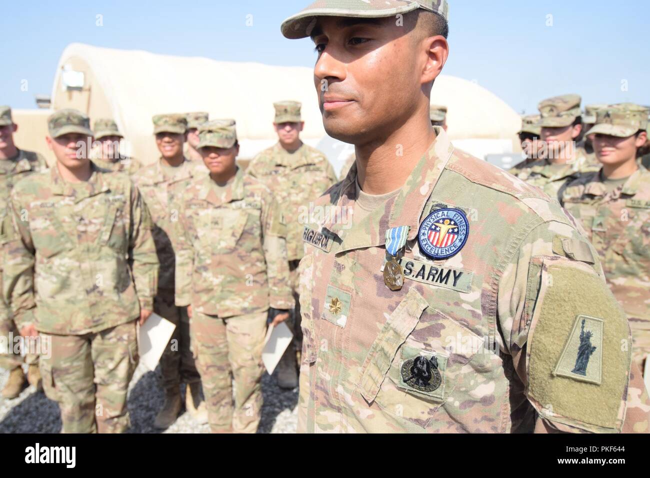CAMP ARIFJAN, Kuwait – Lt. Col. Charles A. Valdes(left), =awards an ...