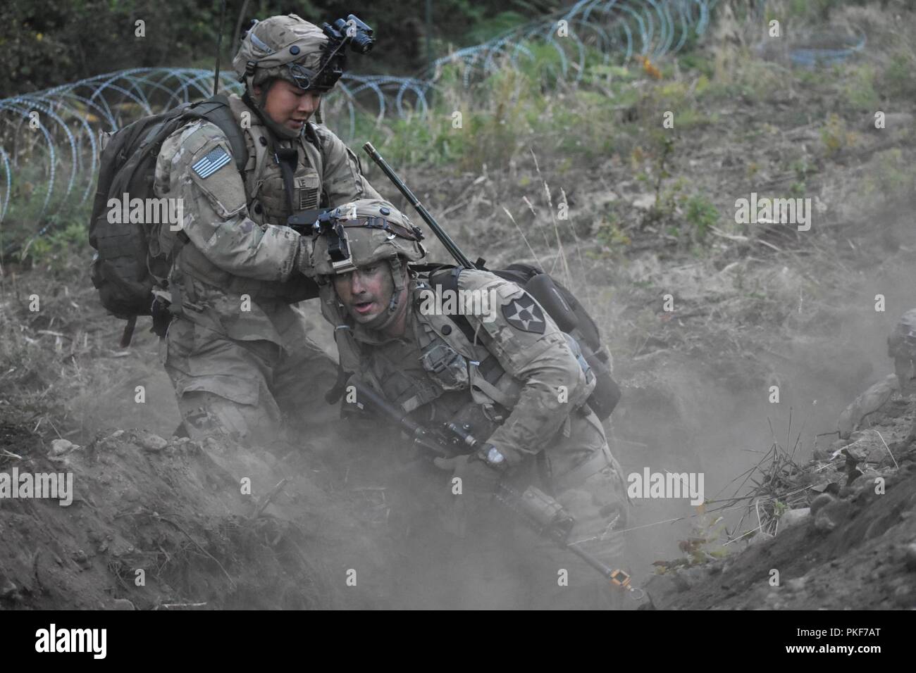 A radio telephone operator assists a fellow RTO from 4th Battalion ...