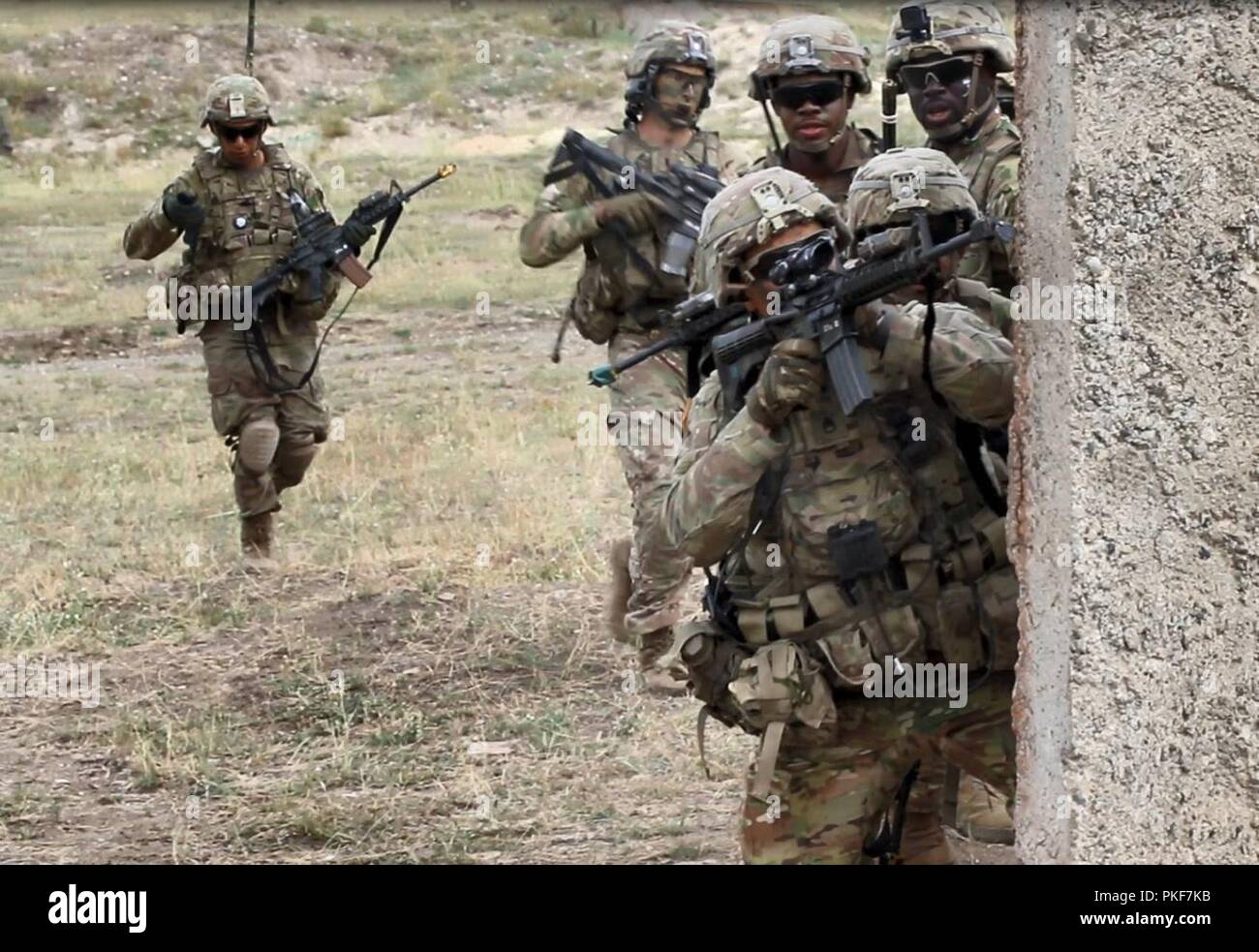 Soldiers with 3rd Squadron, 2d Cavalry Regiment take cover behind a ...